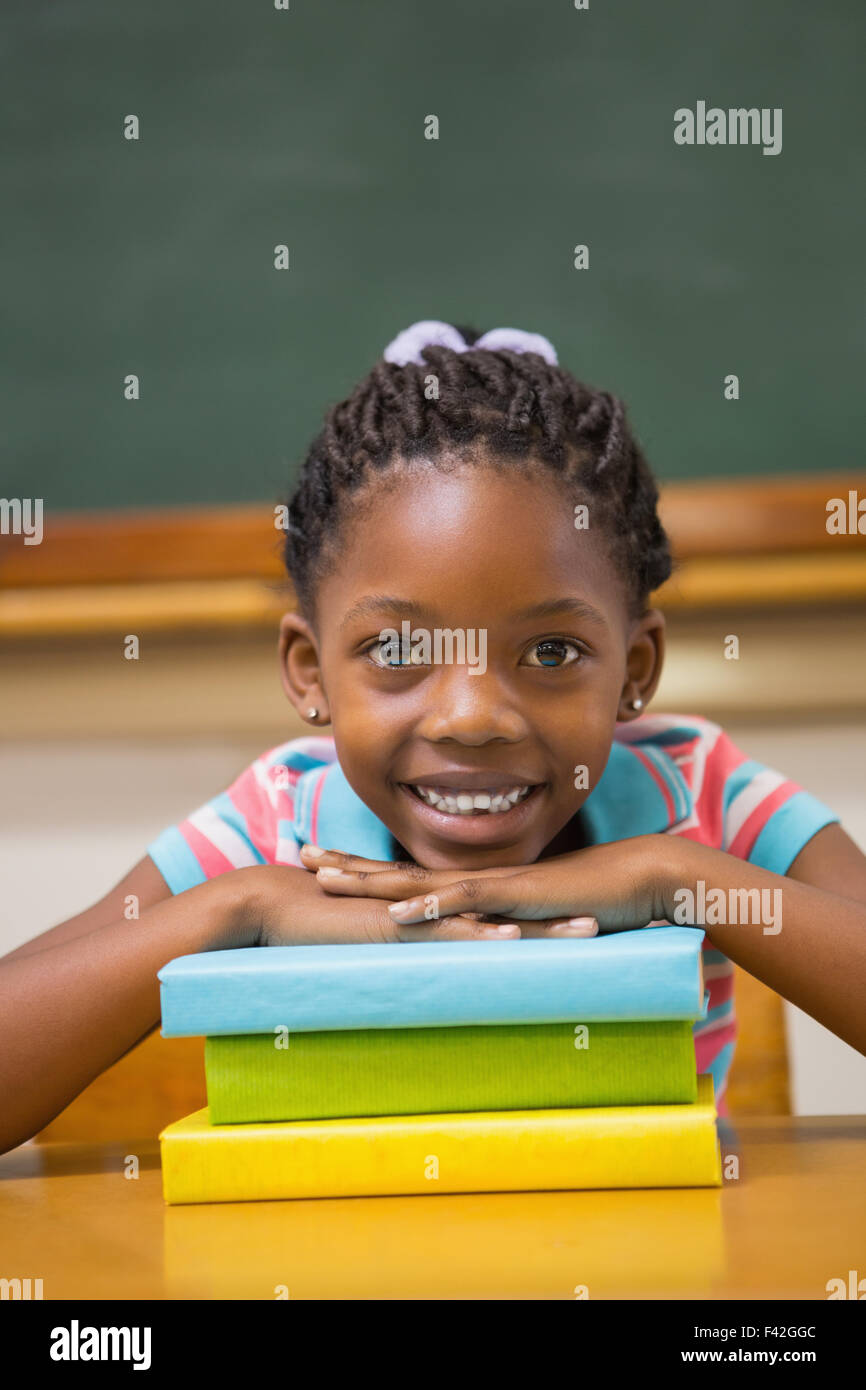 Smiling pupil sitting at her desk Stock Photo - Alamy