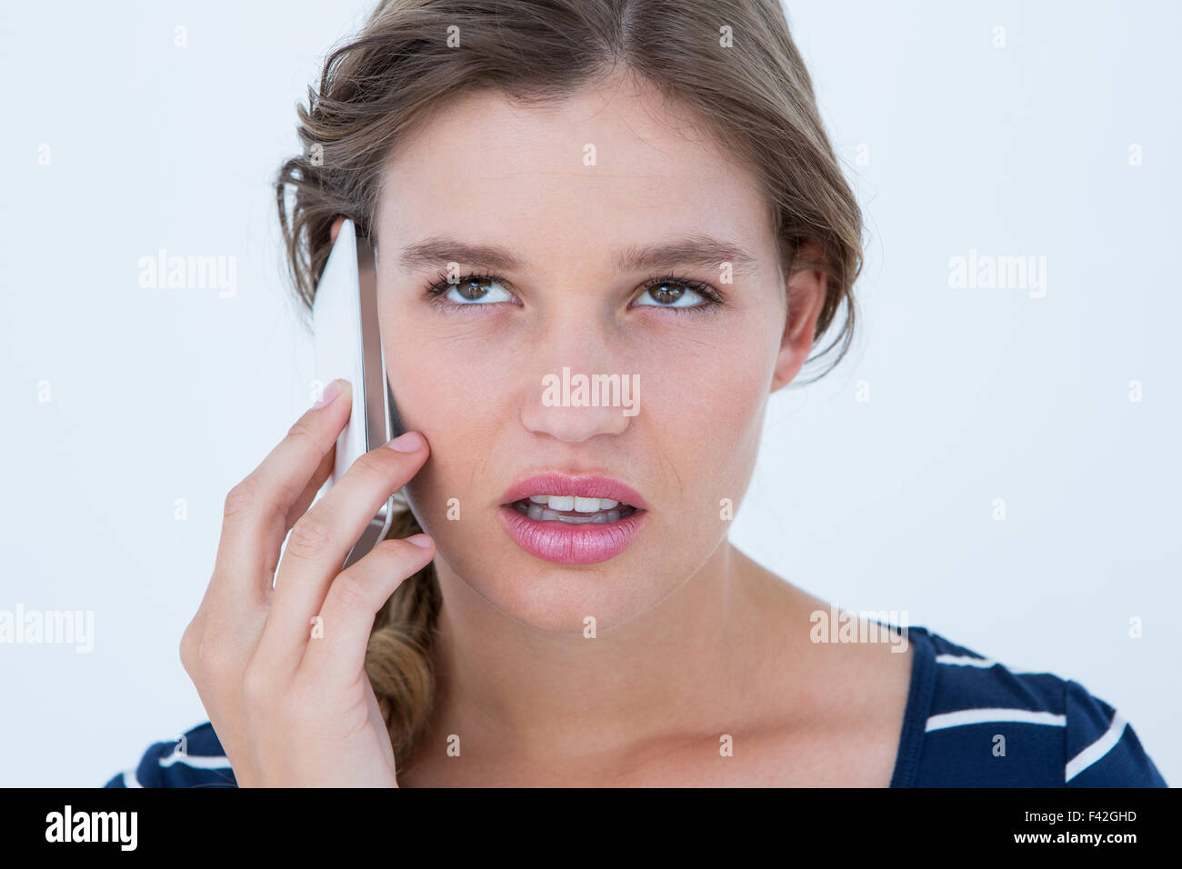 Unsmiling woman calling with her smartphone Stock Photo - Alamy