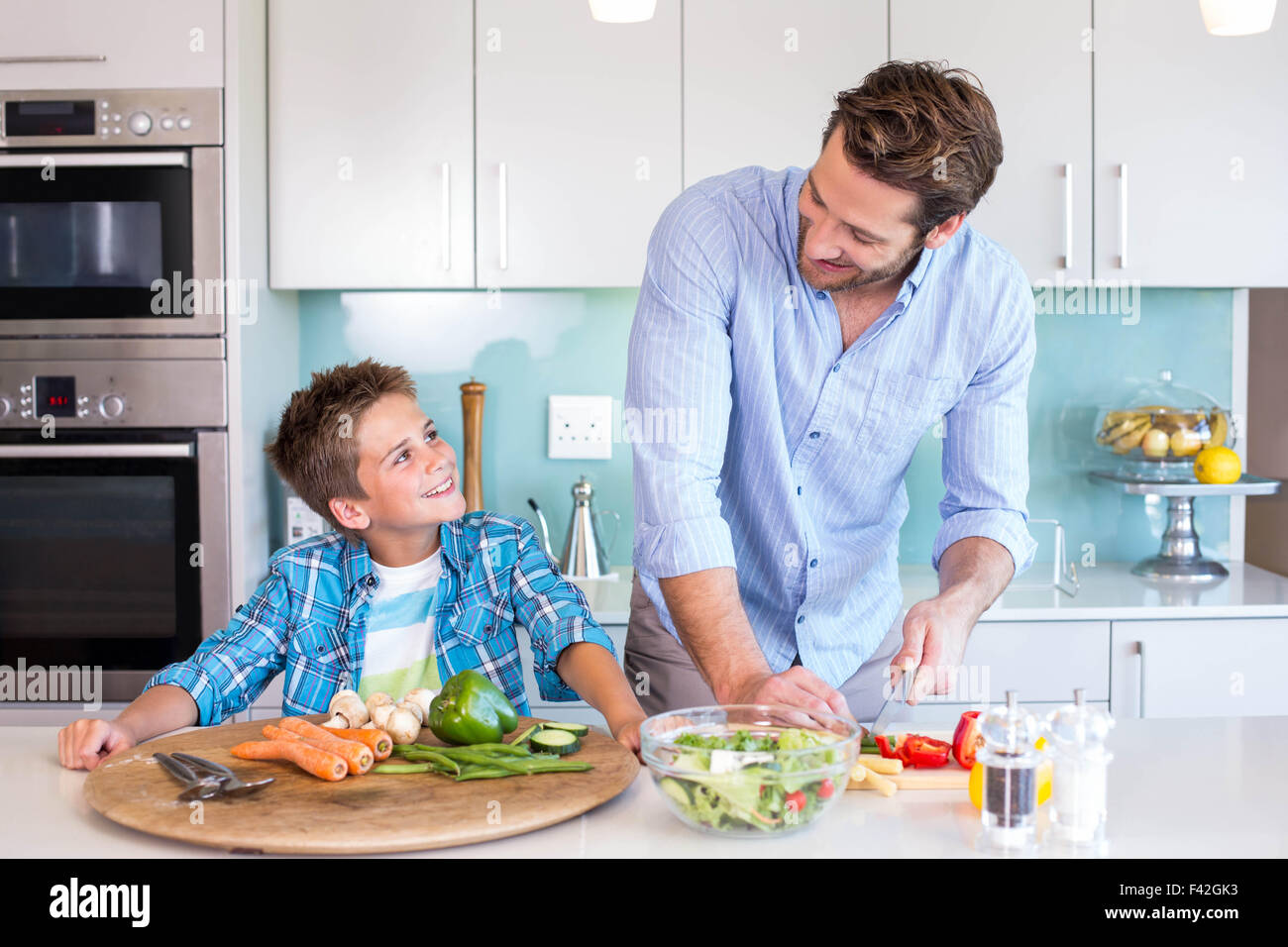 Happy family preparing lunch together Stock Photo - Alamy