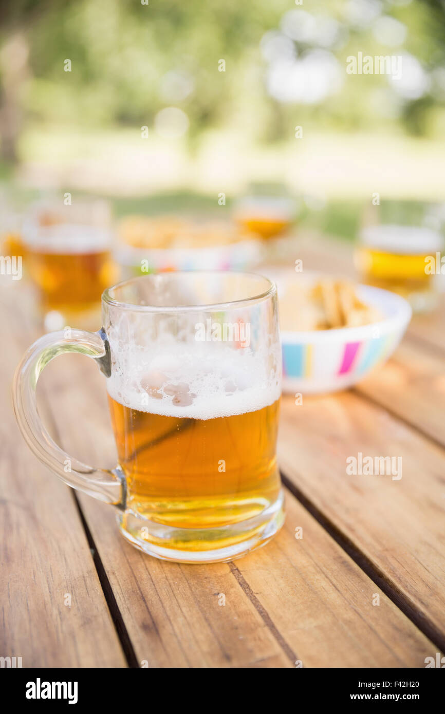 Beer and snacks on picnic table Stock Photo - Alamy