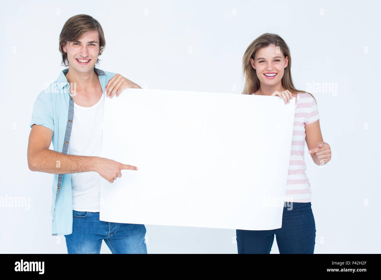 Hipster couple holding poster Stock Photo - Alamy