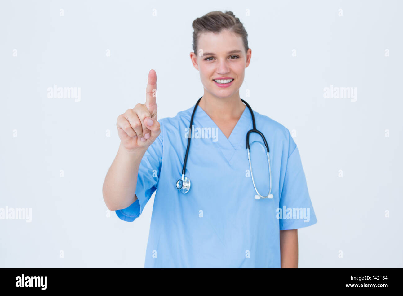 Smiling nurse pointing something Stock Photo - Alamy