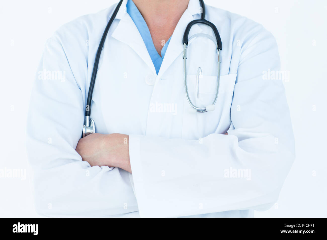 Doctor standing arms crossed Stock Photo - Alamy