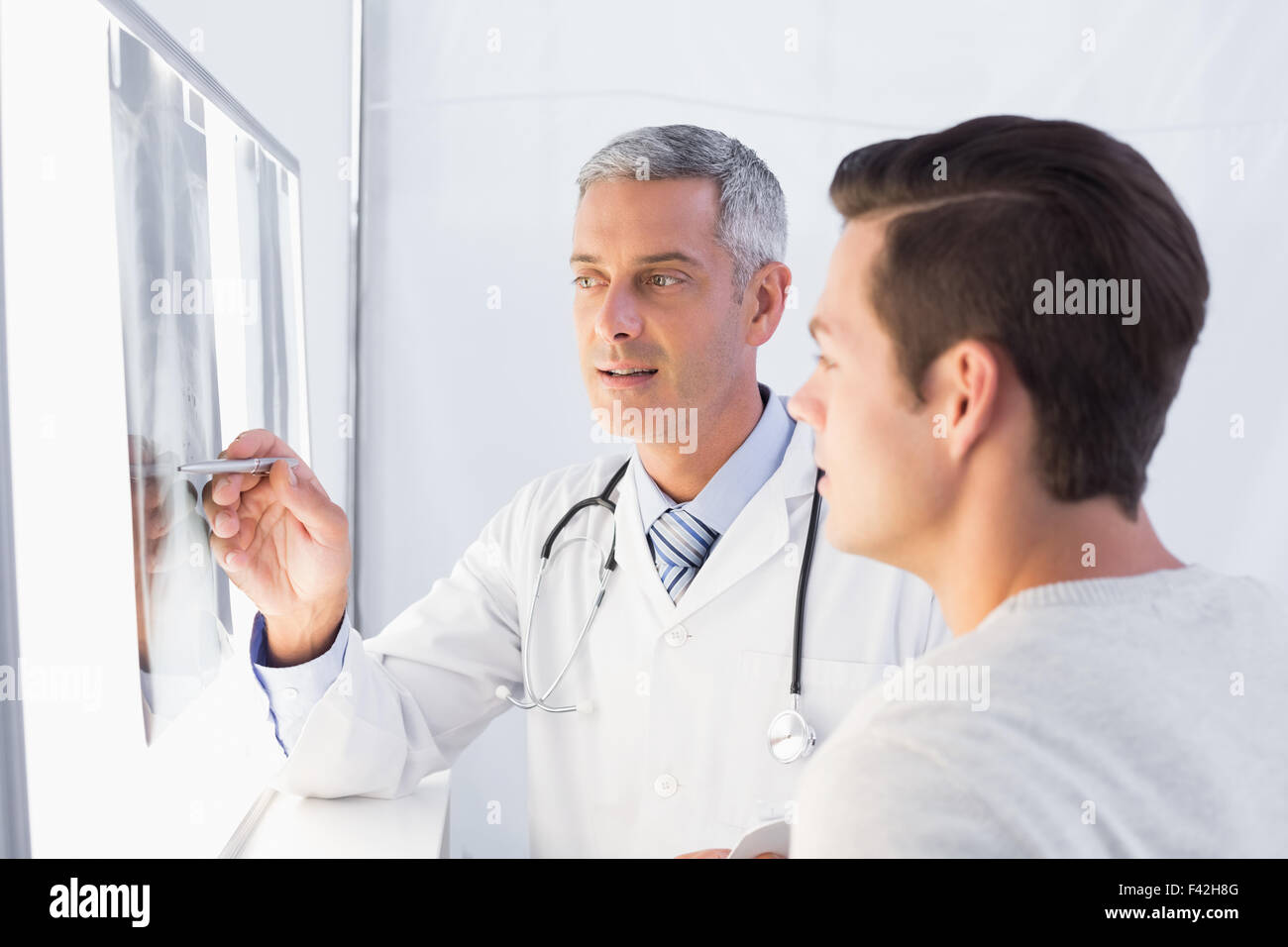 Doctor showing X rays to his patient Stock Photo - Alamy