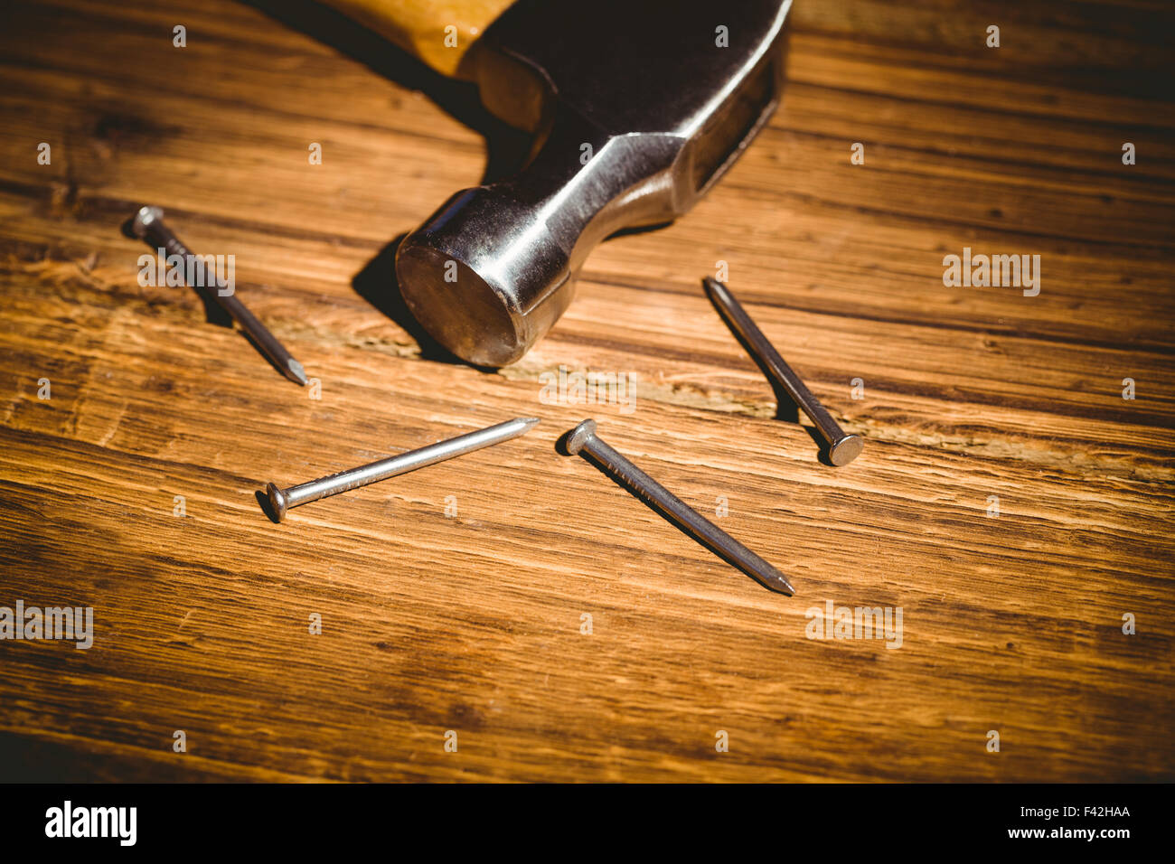 Hammer and nails laid out on table Stock Photo - Alamy