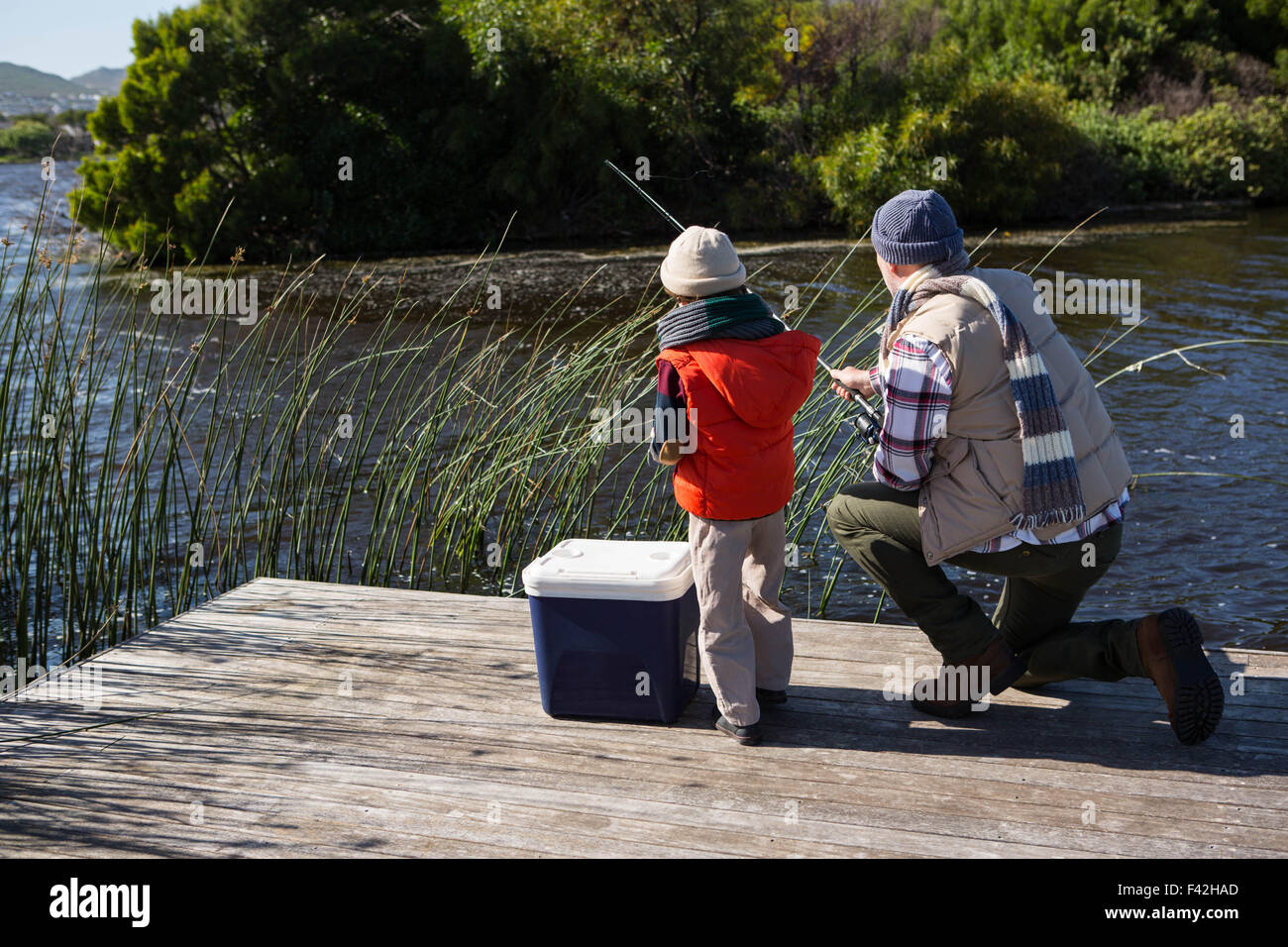 Happy man fishing with his son Stock Photo - Alamy