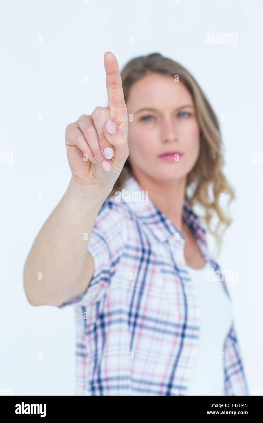 Concentrated pretty hipster pointing Stock Photo - Alamy