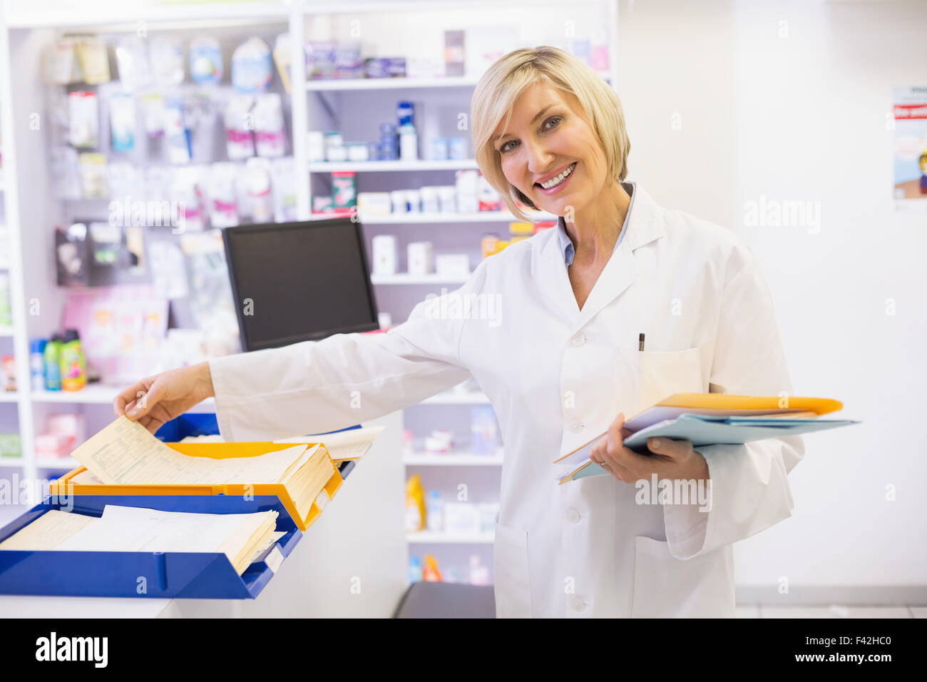 Pharmacist files documents Stock Photo - Alamy