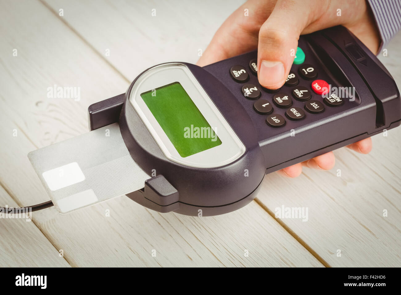 Man entering his pin on terminal Stock Photo - Alamy