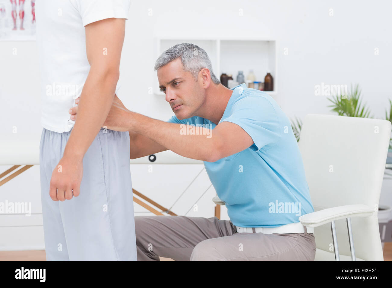 Doctor examining his patient back Stock Photo - Alamy