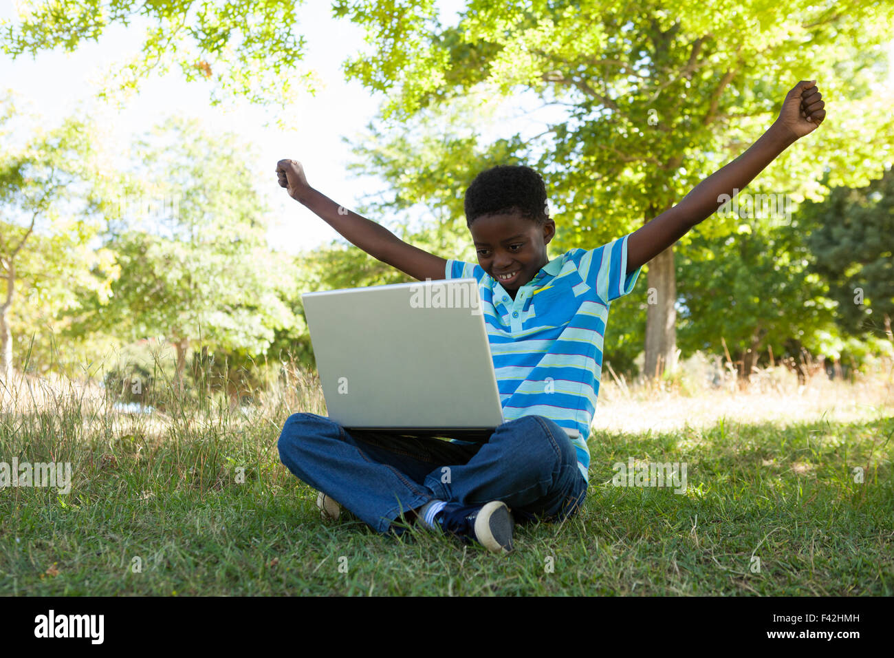 Cute little boy with laptop Stock Photo - Alamy