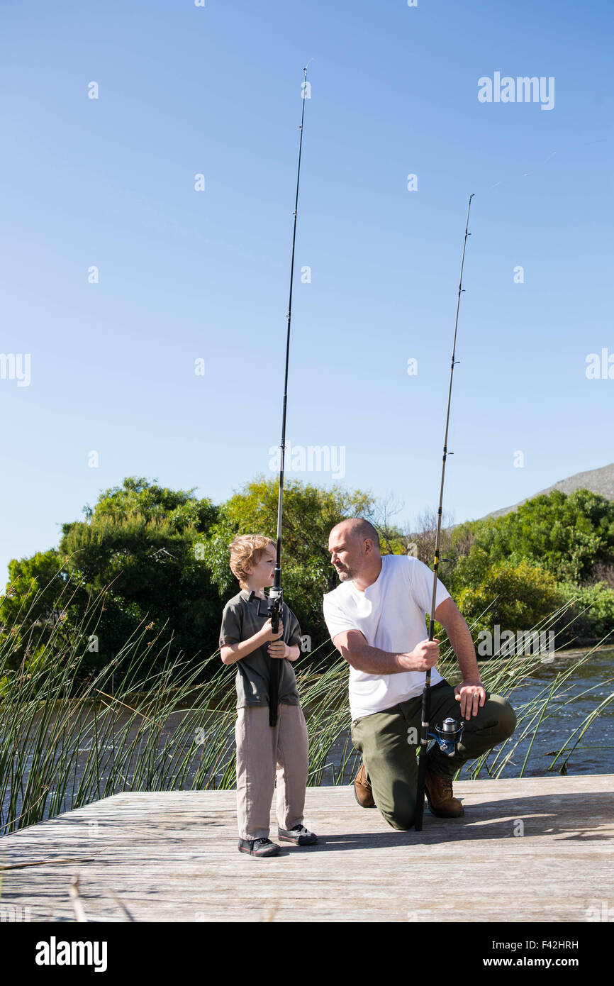 Happy man fishing with his son Stock Photo - Alamy