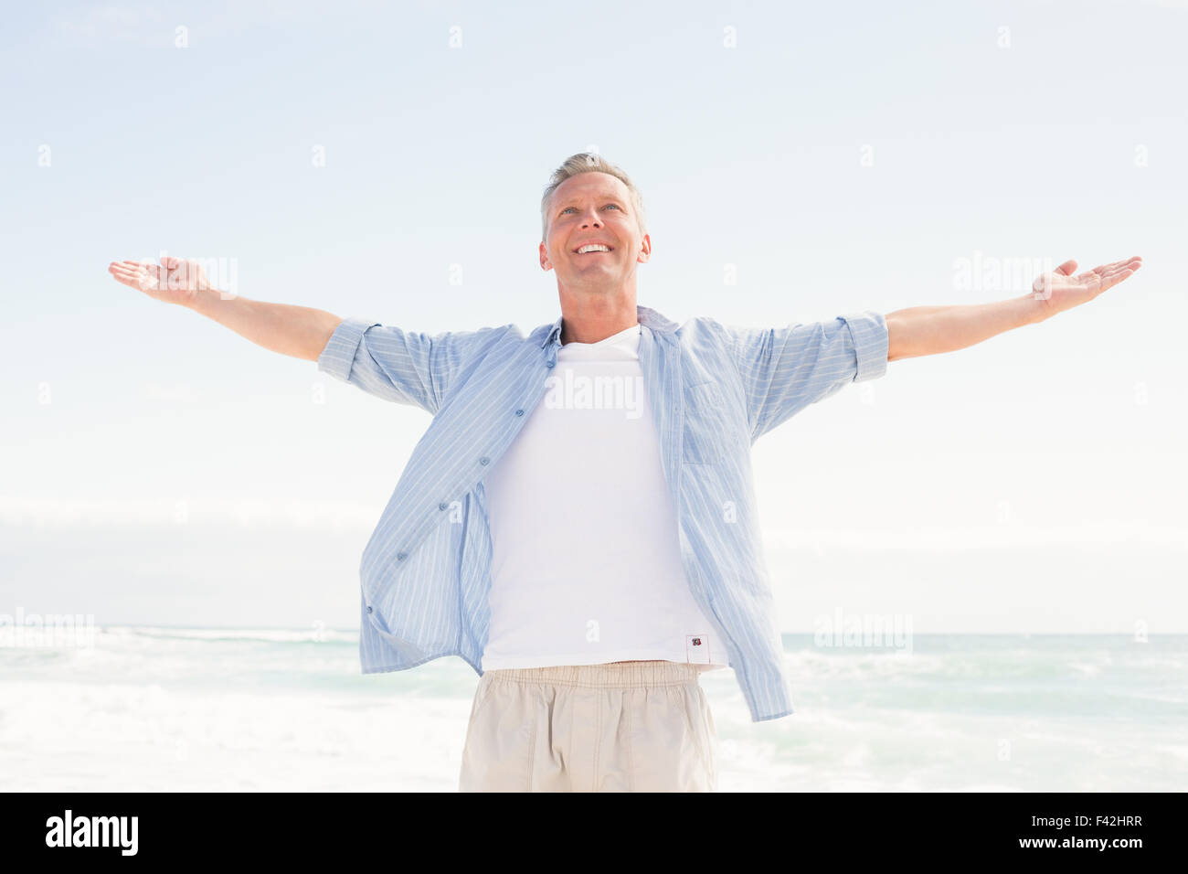 Handsome man with arms outstretched Stock Photo - Alamy