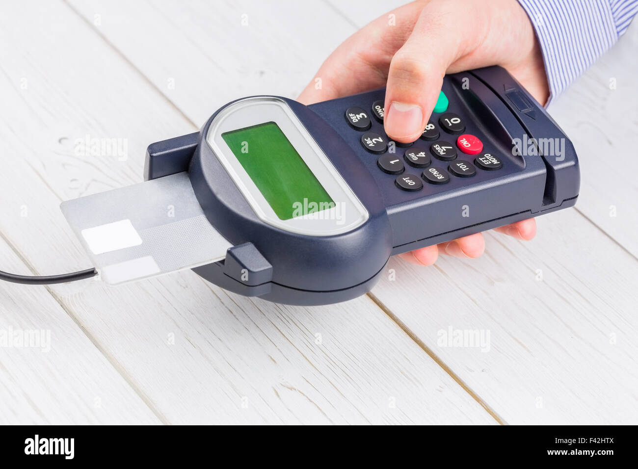 Man entering his pin on terminal Stock Photo - Alamy
