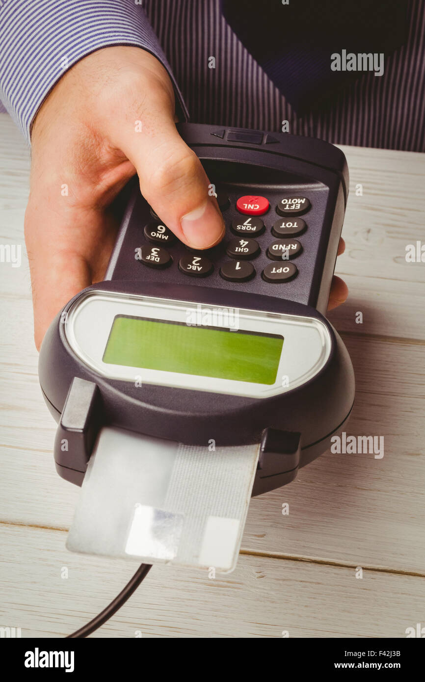 Man entering his pin on terminal Stock Photo - Alamy