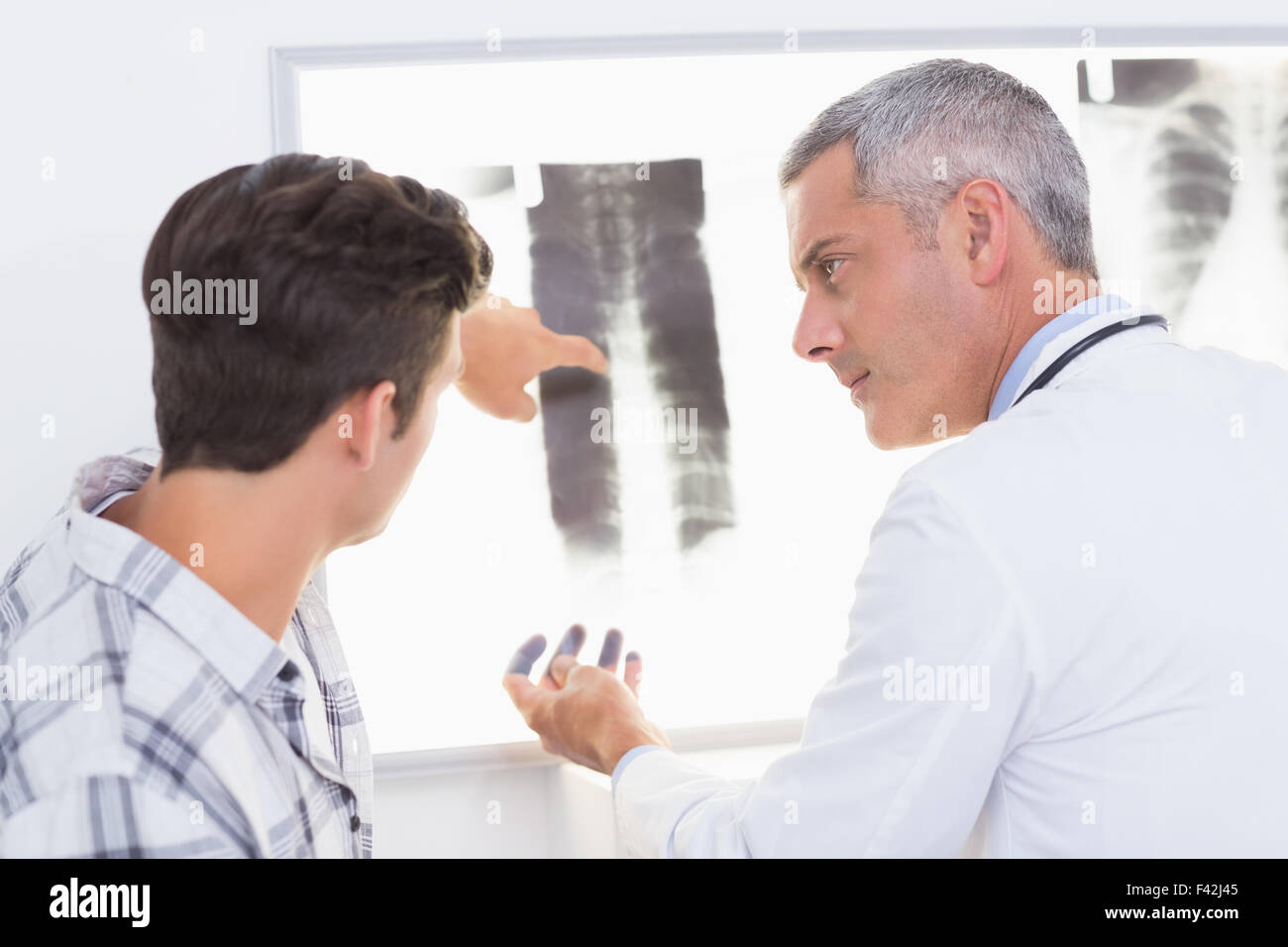 Doctor explaining X rays to his patient Stock Photo - Alamy