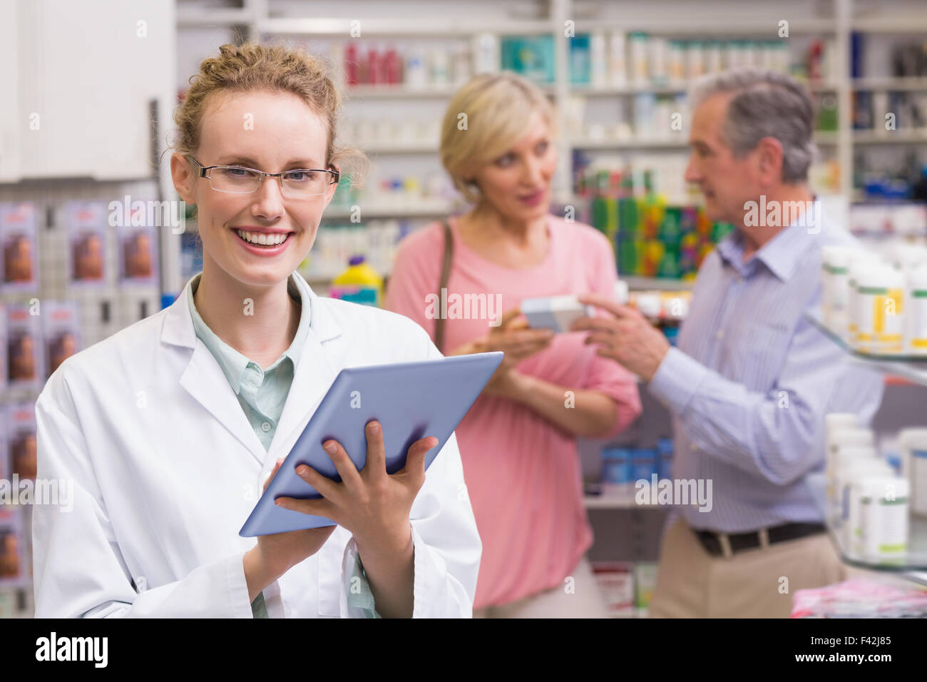 Pharmacist using tablet pc Stock Photo - Alamy
