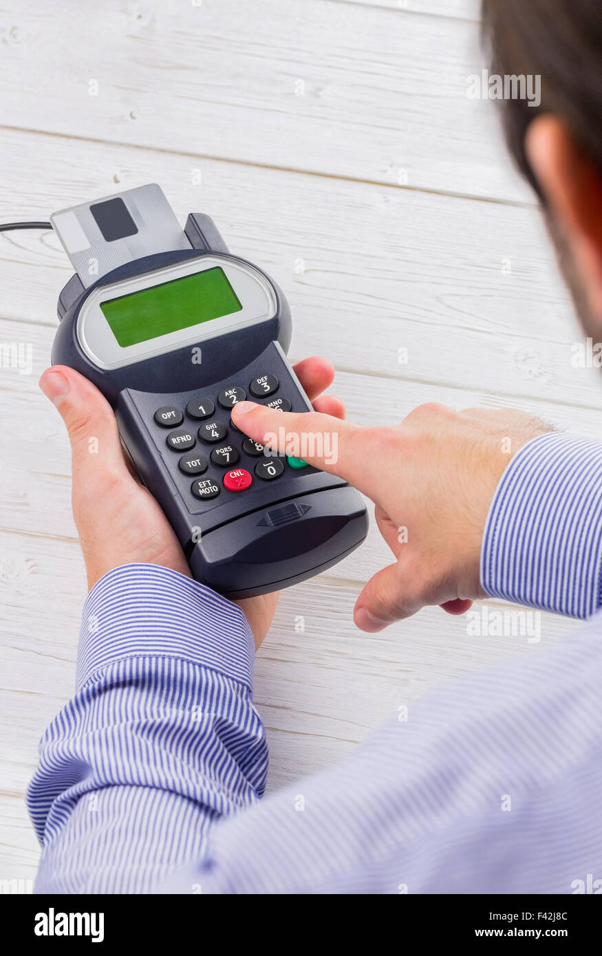Man entering his pin on terminal Stock Photo - Alamy