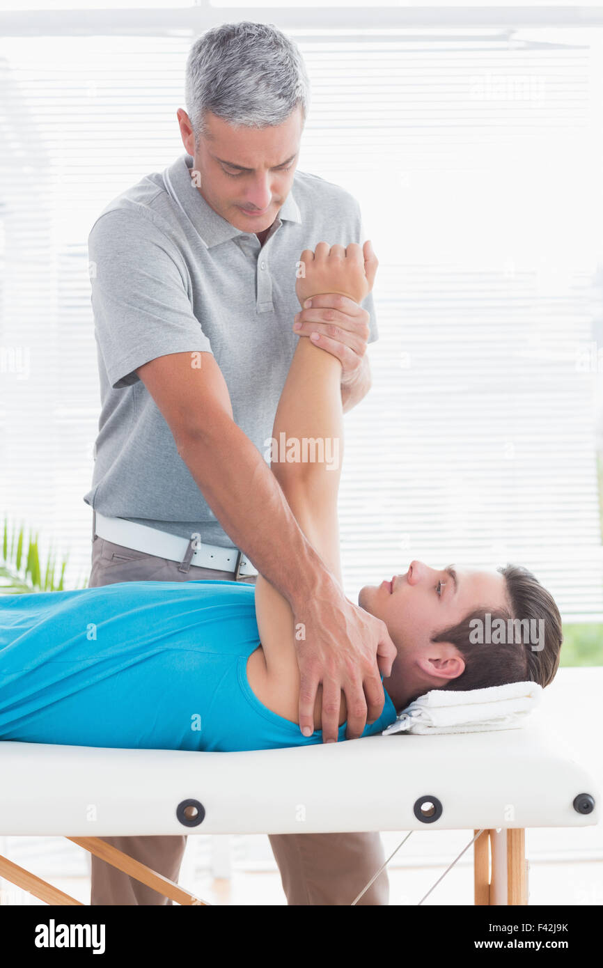 Doctor examining his patient arm Stock Photo - Alamy