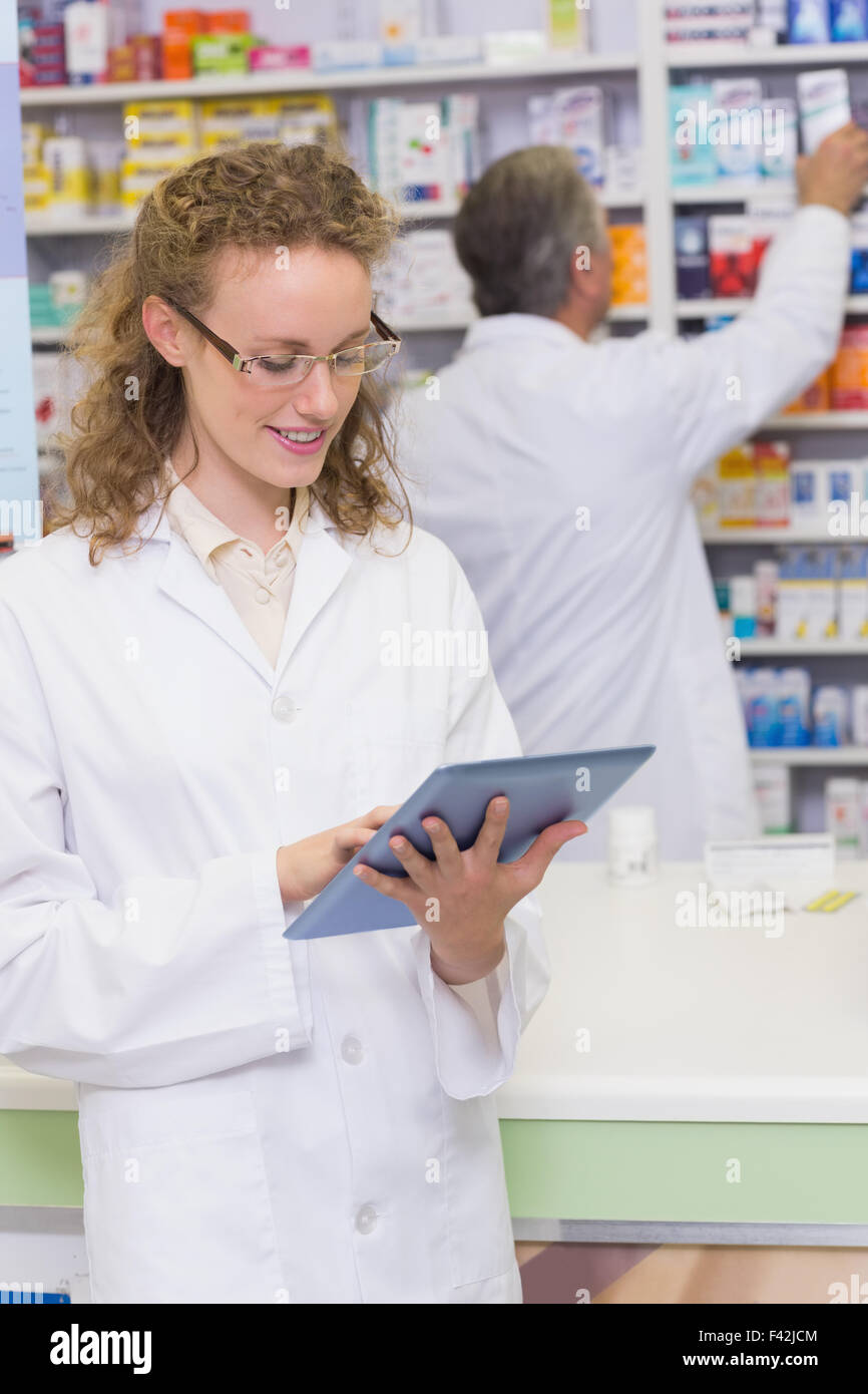 Pharmacist using tablet pc Stock Photo - Alamy