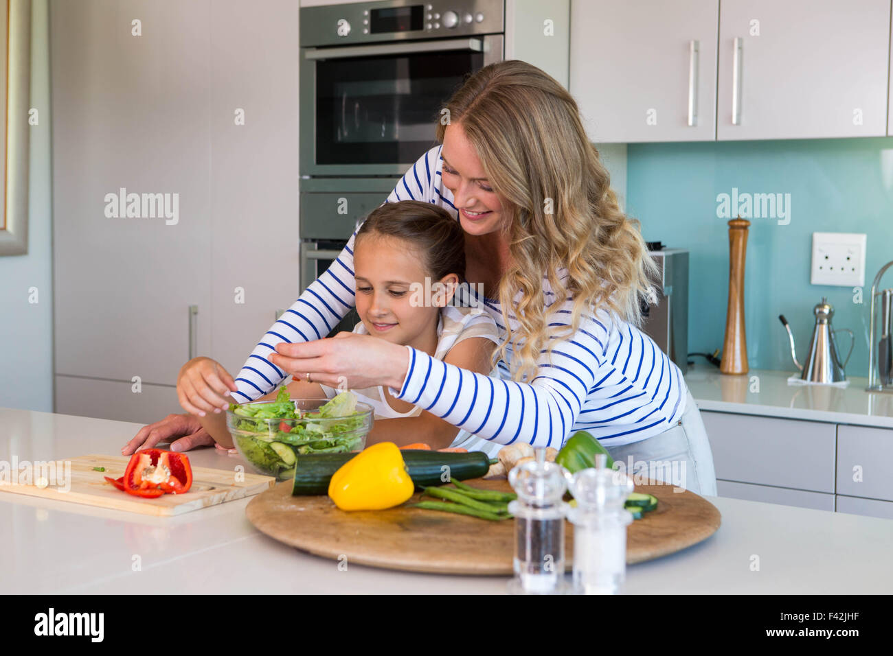 Happy family preparing lunch together Stock Photo - Alamy