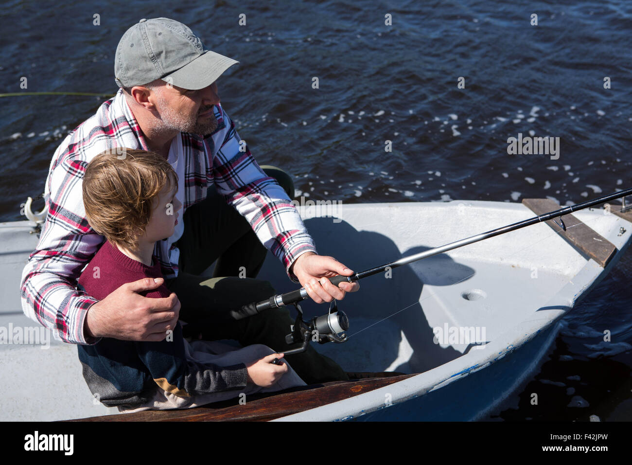Happy man fishing with his son Stock Photo - Alamy
