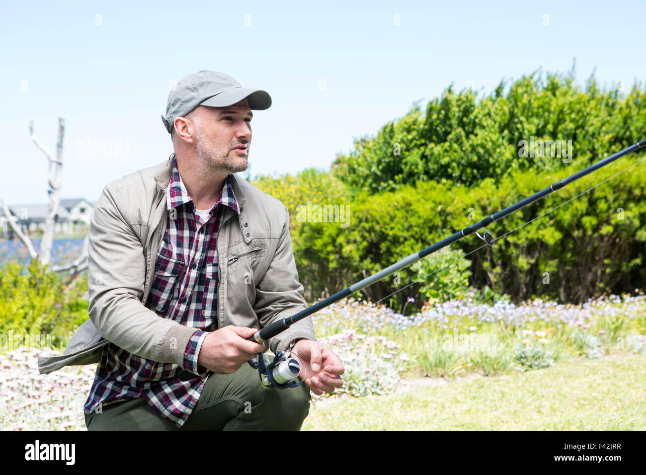 Happy man fishing Stock Photo - Alamy