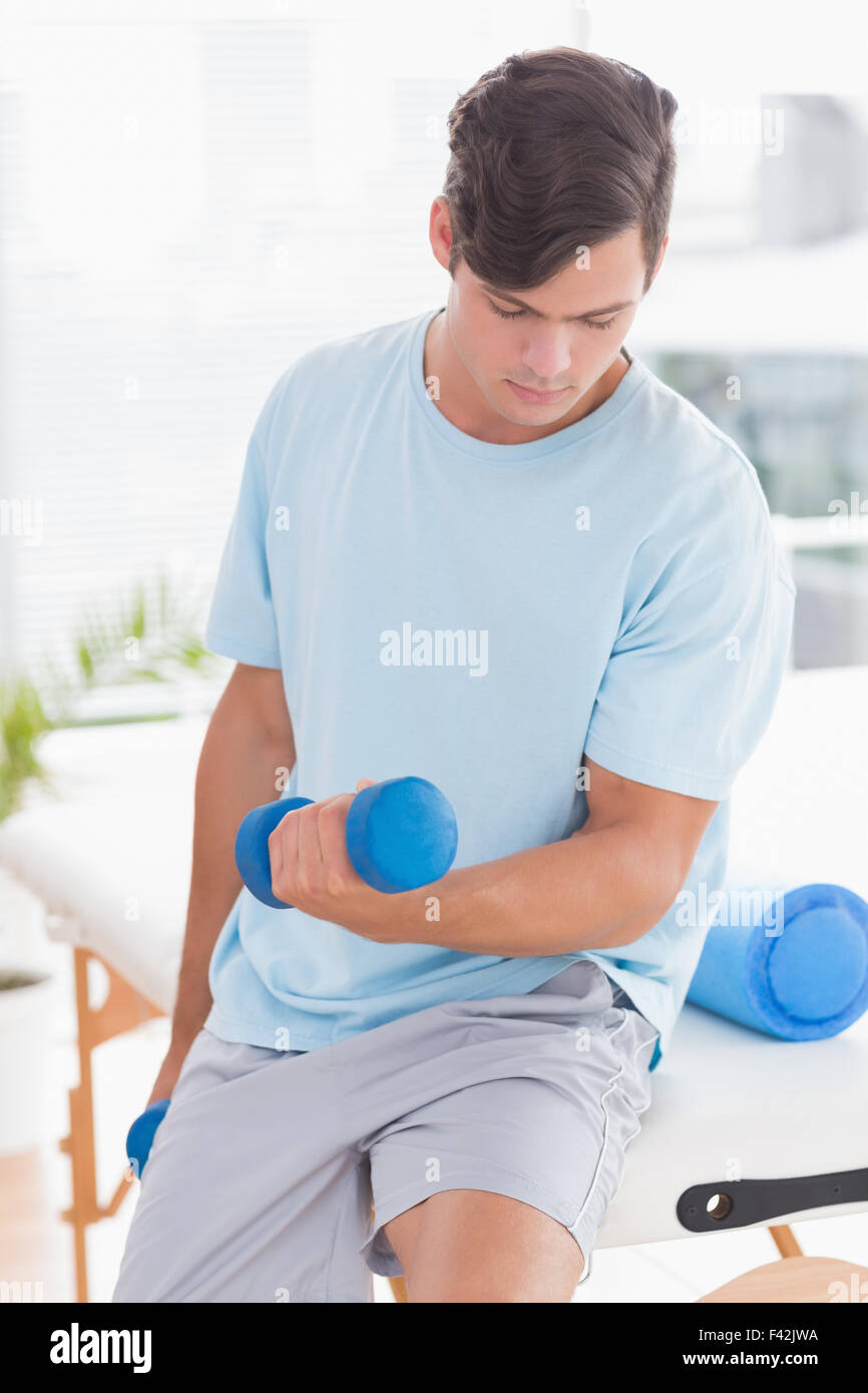 Young man training with dumbbells Stock Photo - Alamy
