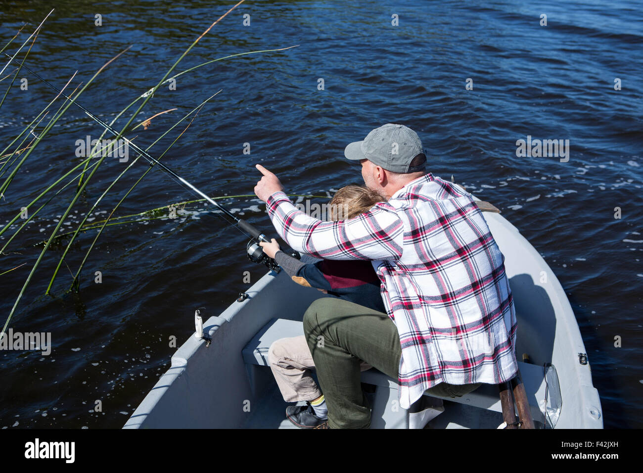 Happy man fishing with his son Stock Photo - Alamy