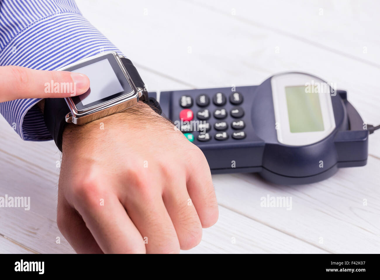 Man using smart watch to express pay Stock Photo - Alamy