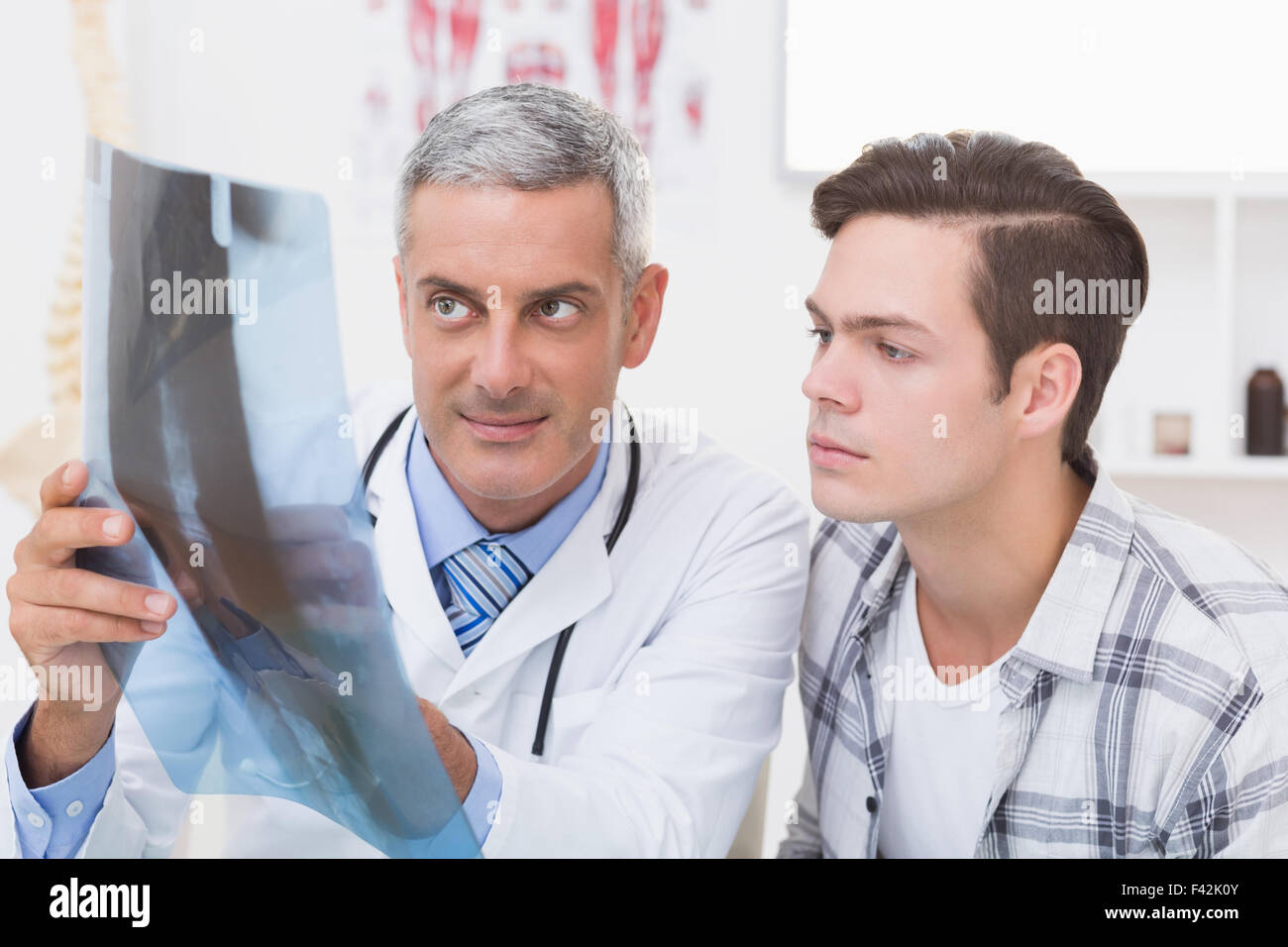 Doctor showing X rays to his patient Stock Photo - Alamy
