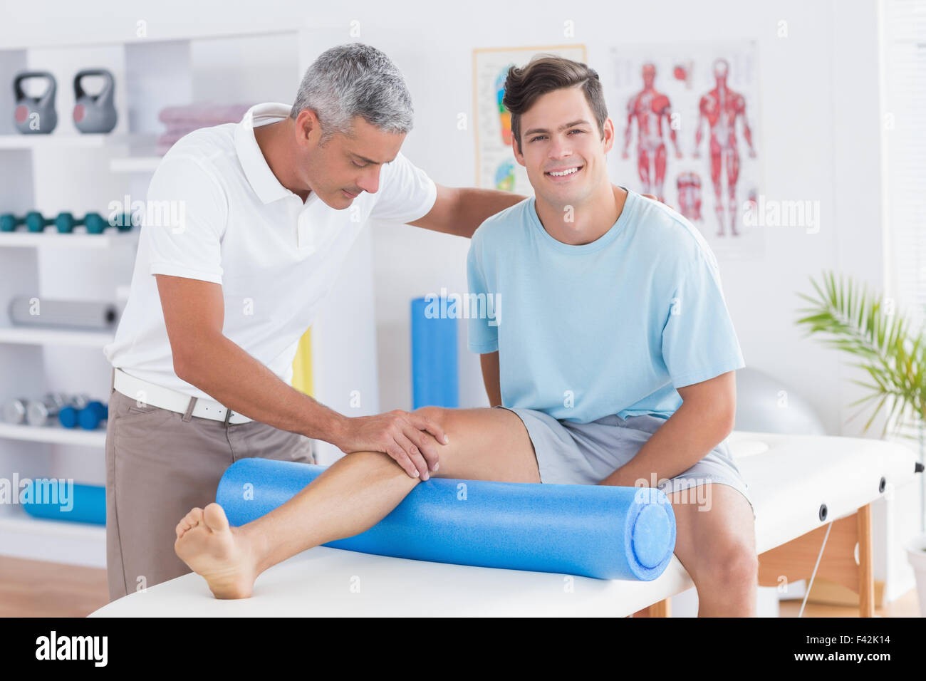 Doctor examining his patient leg Stock Photo - Alamy