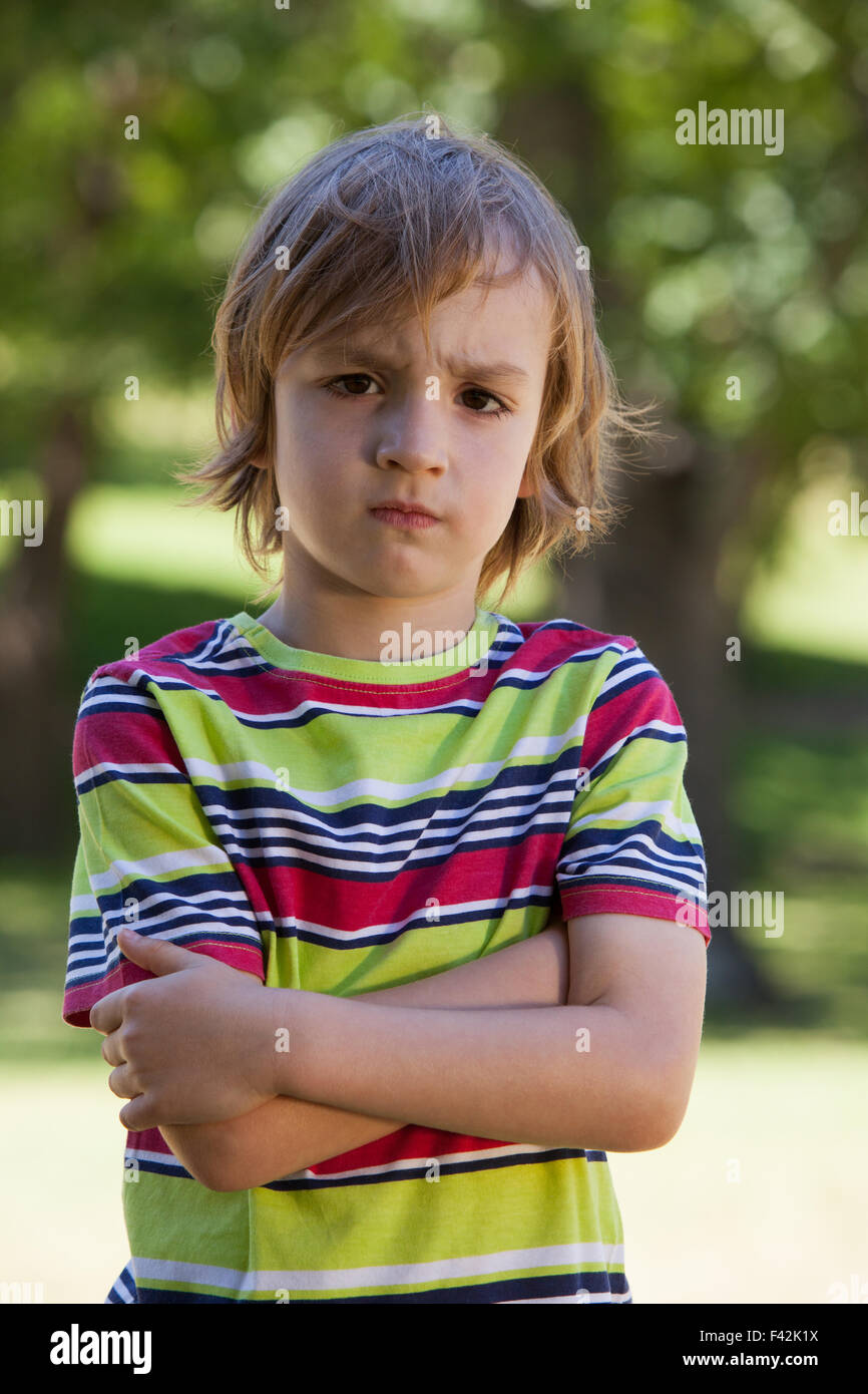 Sad little boy in the park Stock Photo - Alamy
