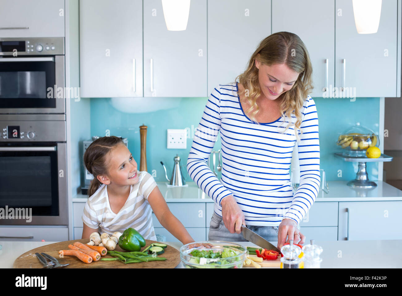 Happy family preparing lunch together Stock Photo - Alamy
