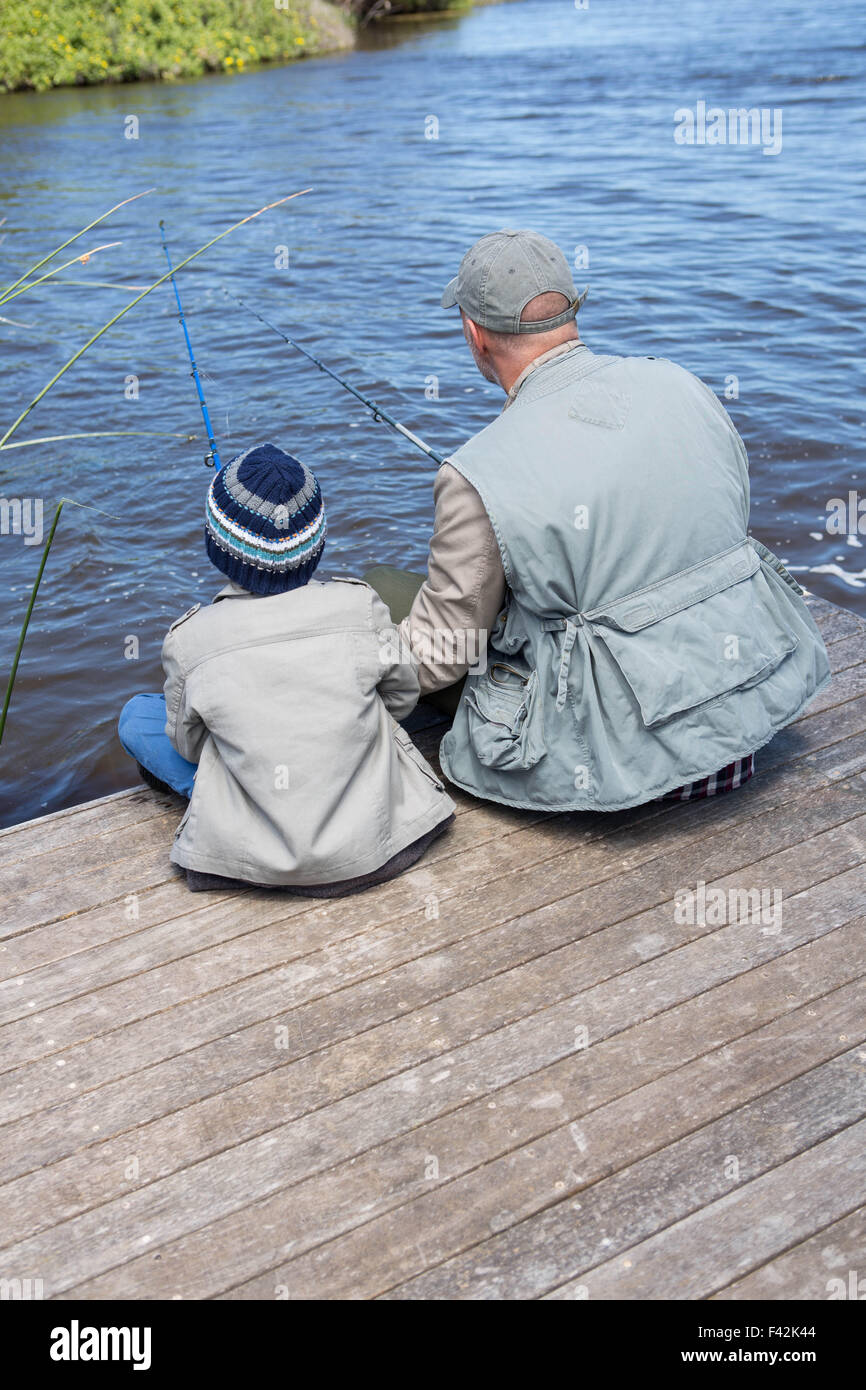 Father and son fishing at a lake Stock Photo - Alamy
