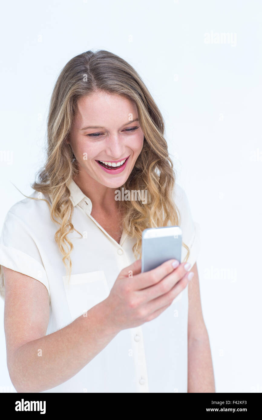 Smiling woman texting with her smartphone Stock Photo - Alamy