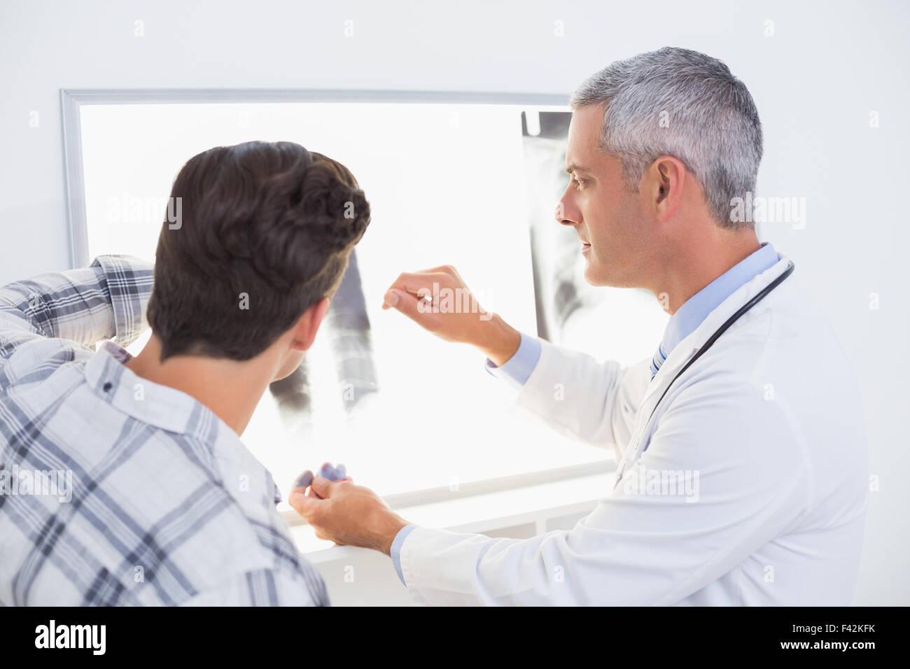 Unsmiling patient with doctor hi-res stock photography and images - Alamy