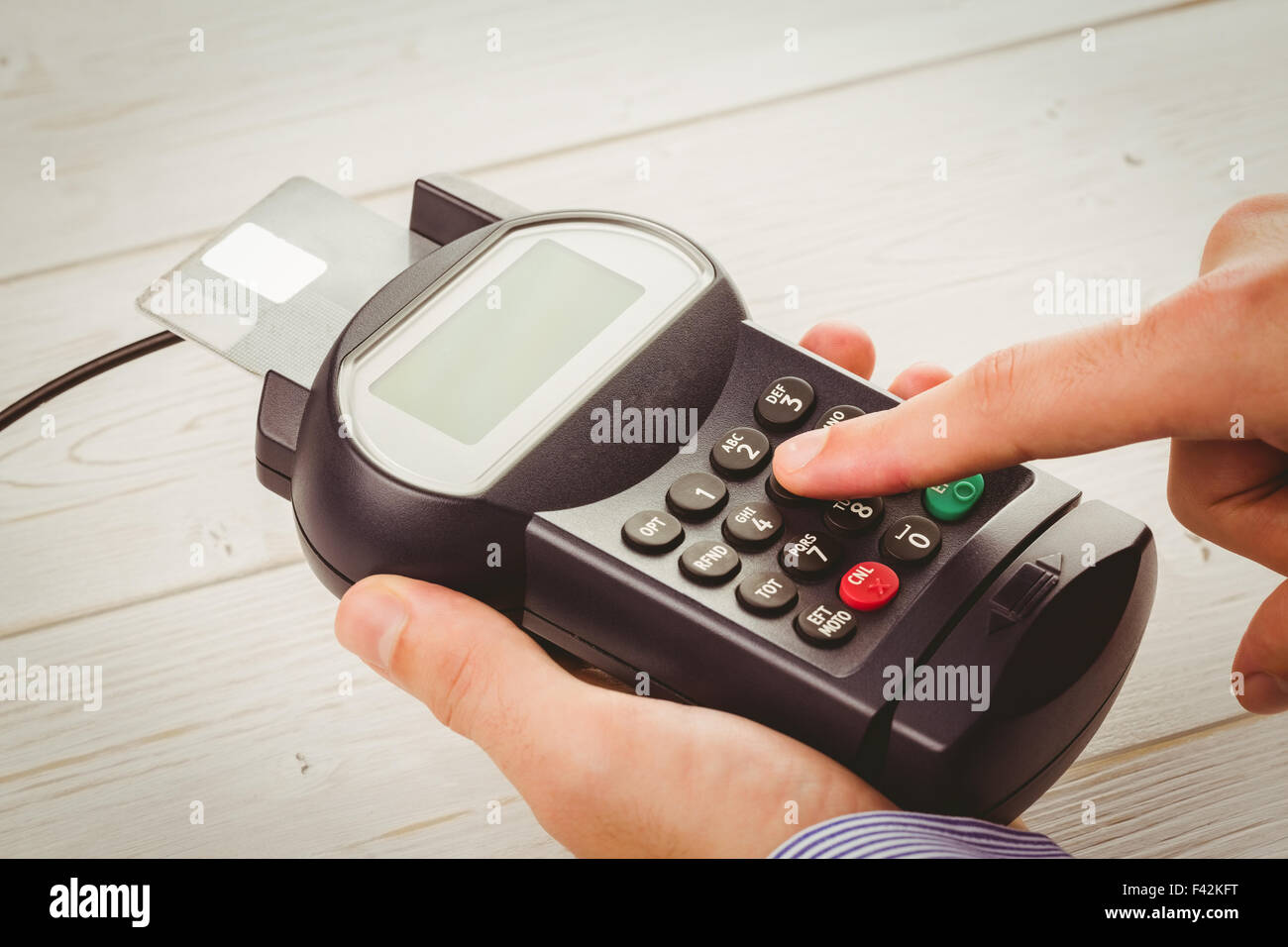 Man entering his pin on terminal Stock Photo - Alamy