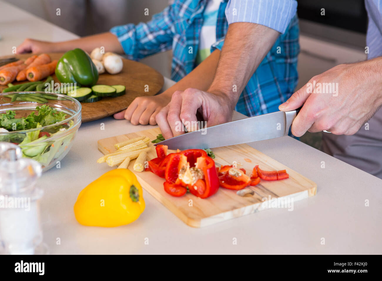 Happy family preparing vegetables together Stock Photo - Alamy