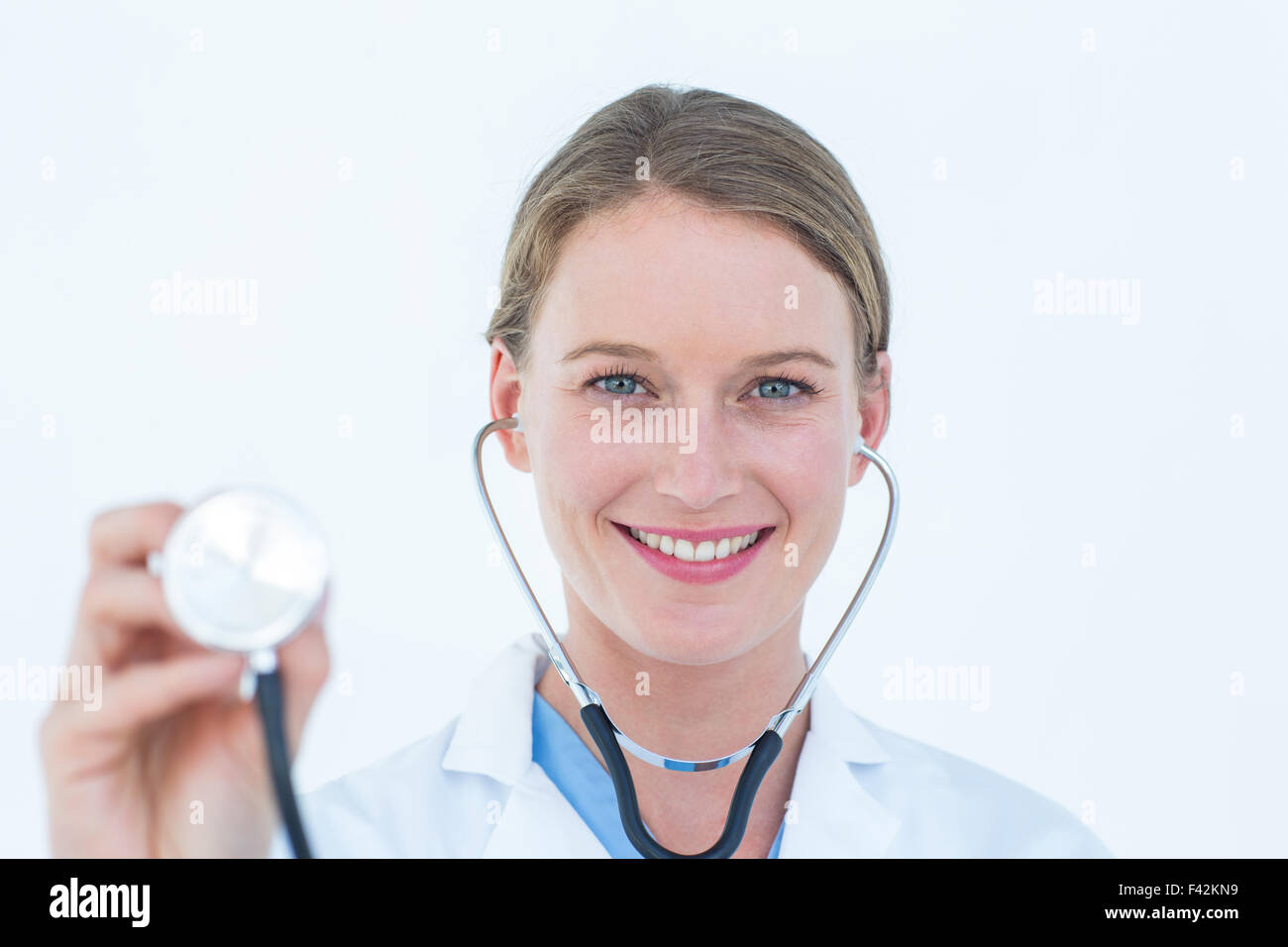 Smiling female doctor holding stethoscope Stock Photo - Alamy