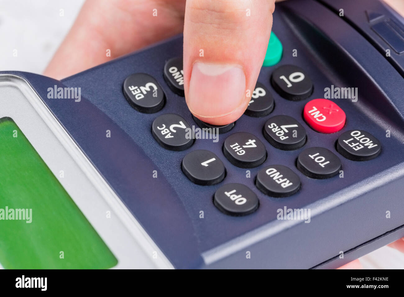 Man entering his pin on terminal Stock Photo - Alamy