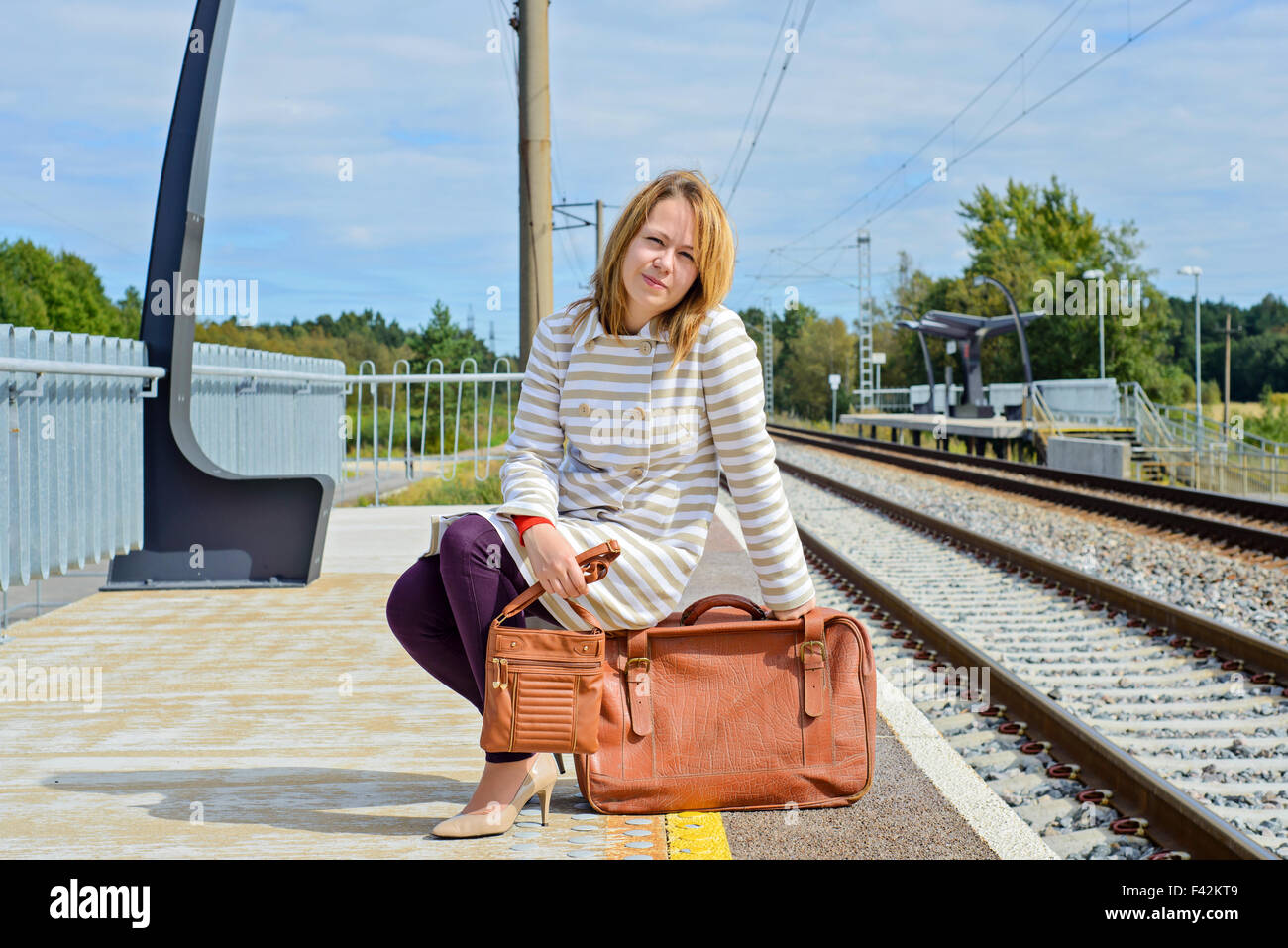 Girl sitting suitcase hi-res stock photography and images - Alamy