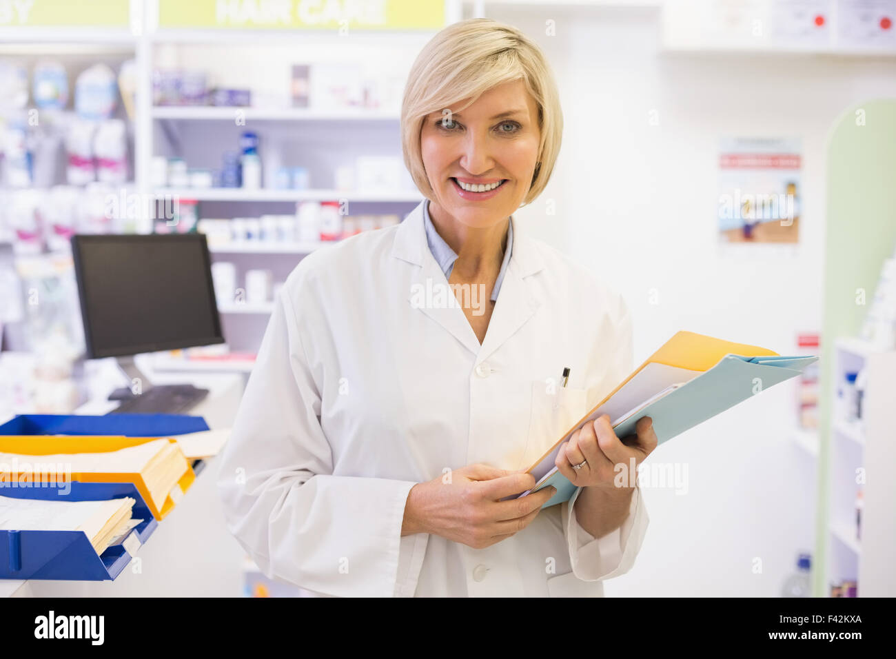 Pharmacist files documents Stock Photo - Alamy