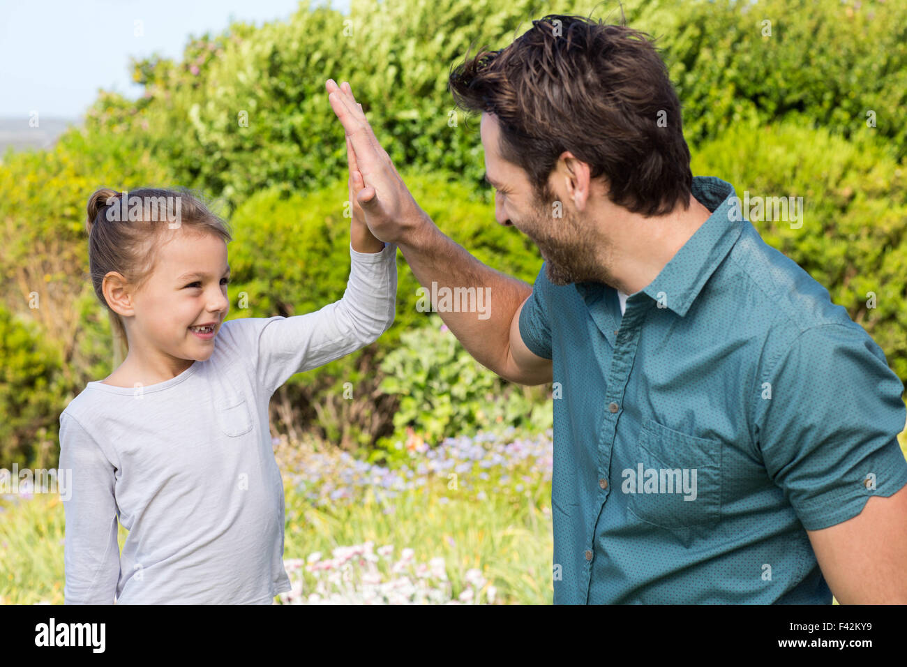 Father and daughter high fiving Stock Photo - Alamy