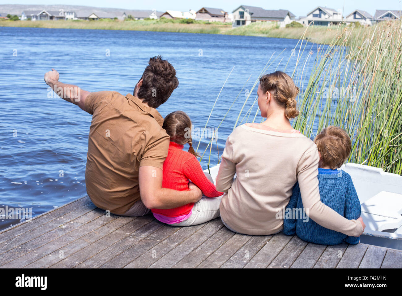 Happy family at a lake Stock Photo - Alamy