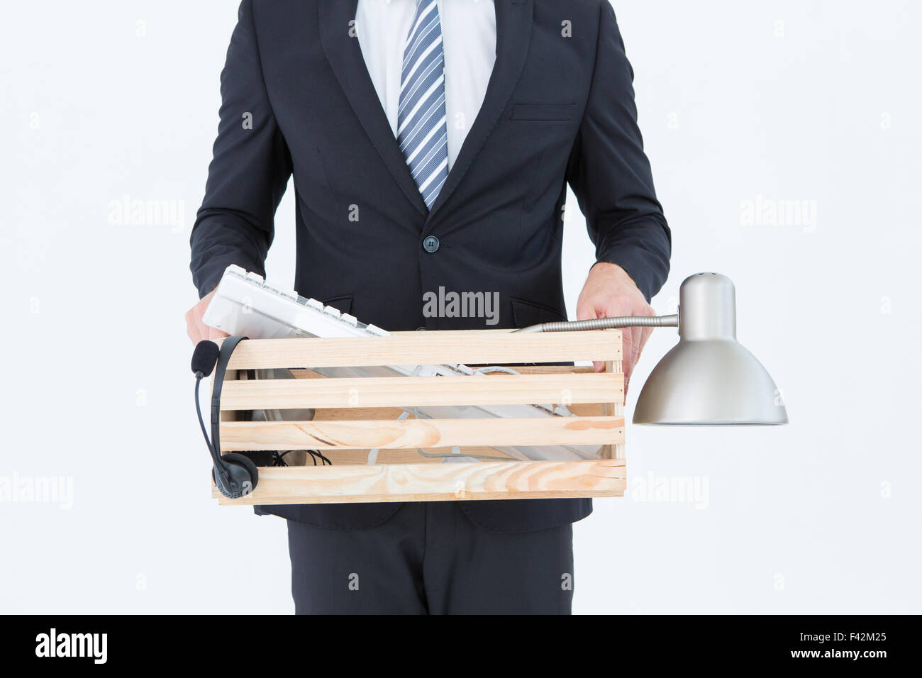 Businessman holding box of his things Stock Photo - Alamy