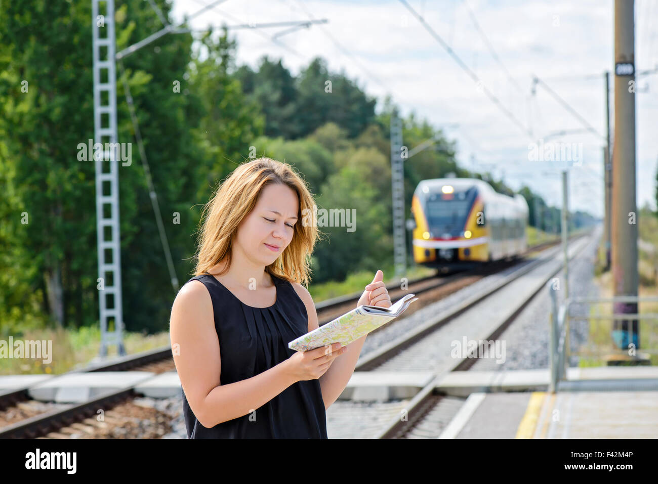Female waiting train on the platform Stock Photo - Alamy