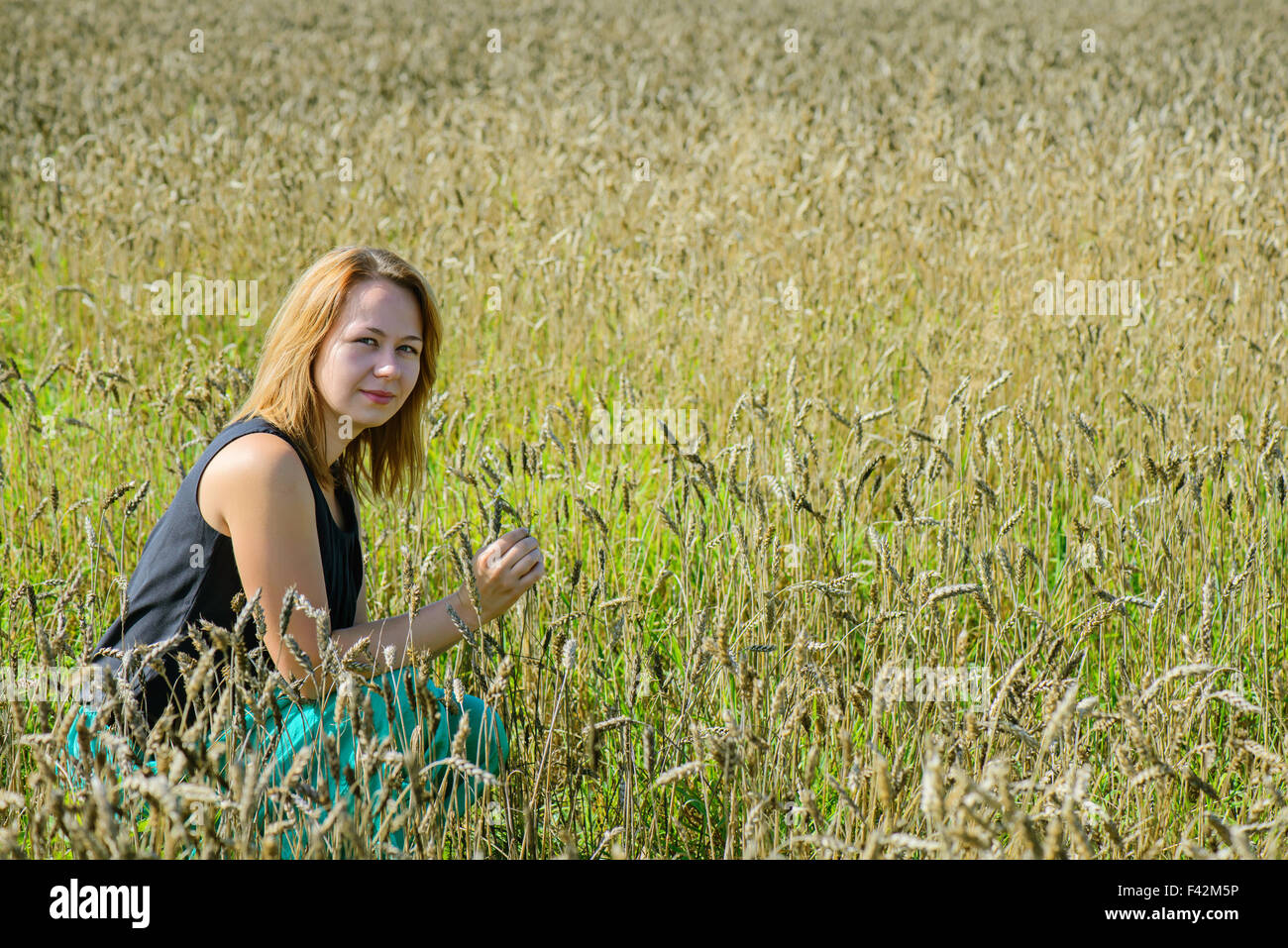 Portrait of woman in field Stock Photo - Alamy