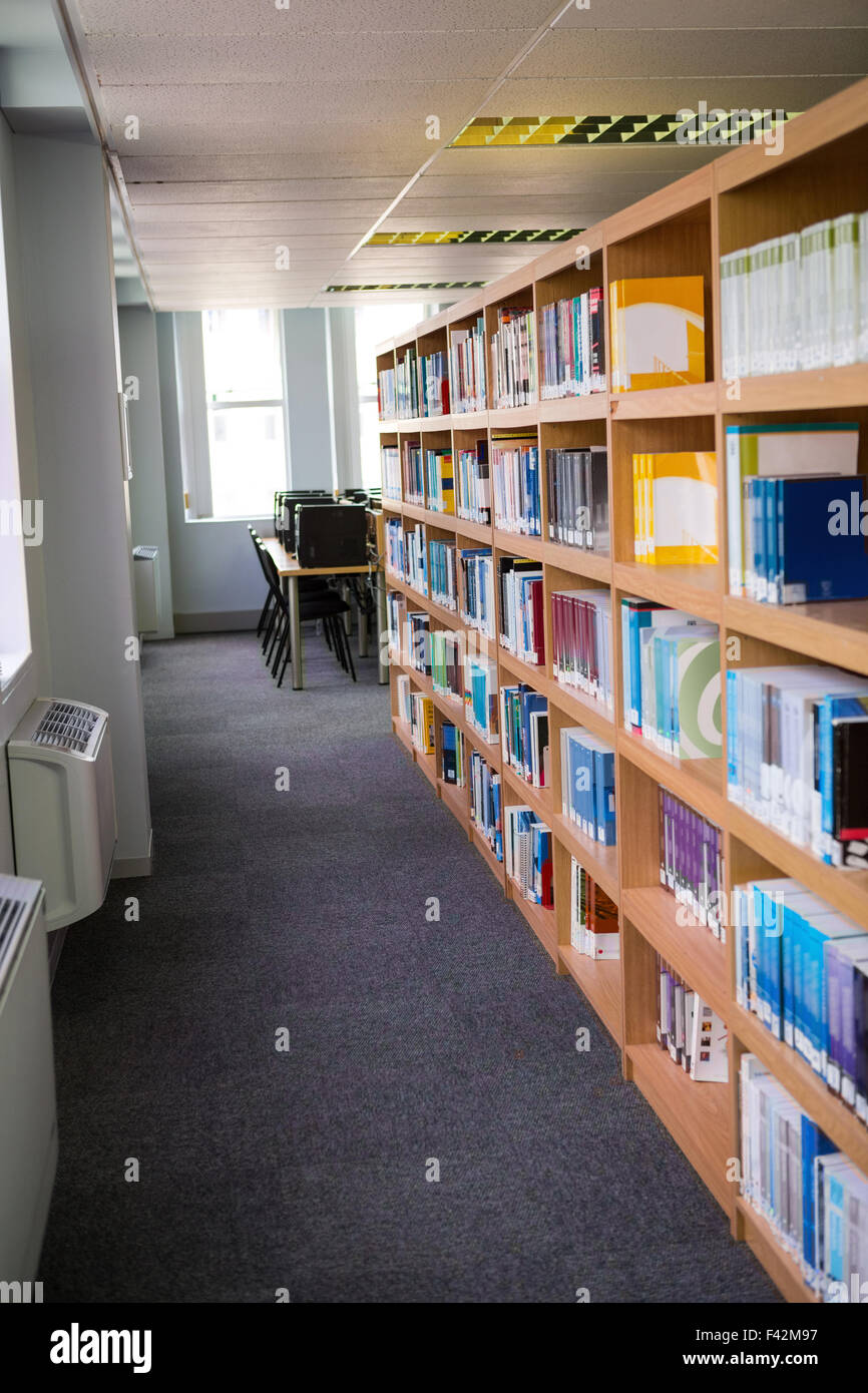 Volumes of books on bookshelf in library Stock Photo - Alamy
