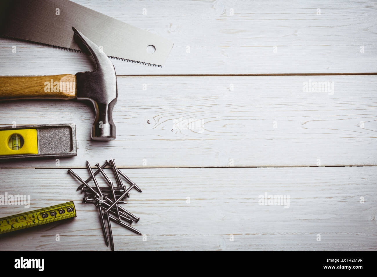 Hammer and nails laid out on table Stock Photo - Alamy